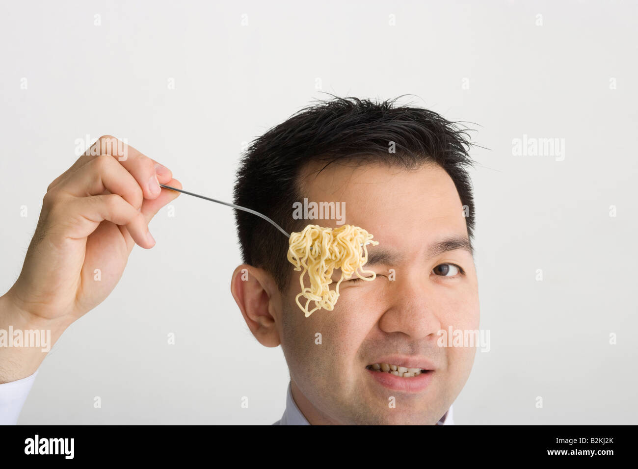 Close-up of a male chef tasting noodles Stock Photo - Alamy
