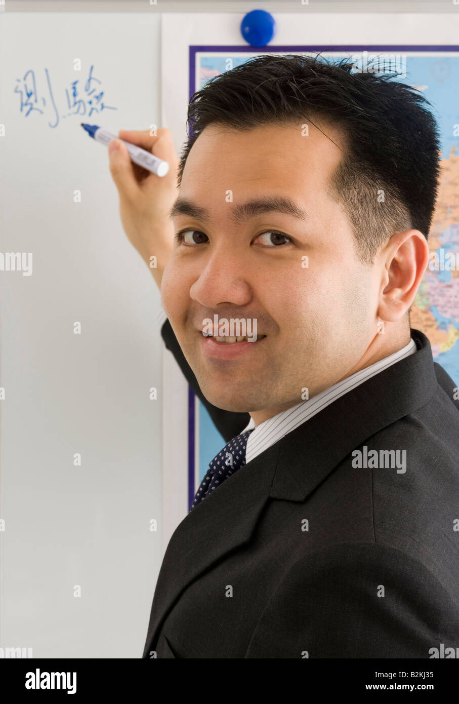 Portrait of a professor writing on a whiteboard Stock Photo - Alamy