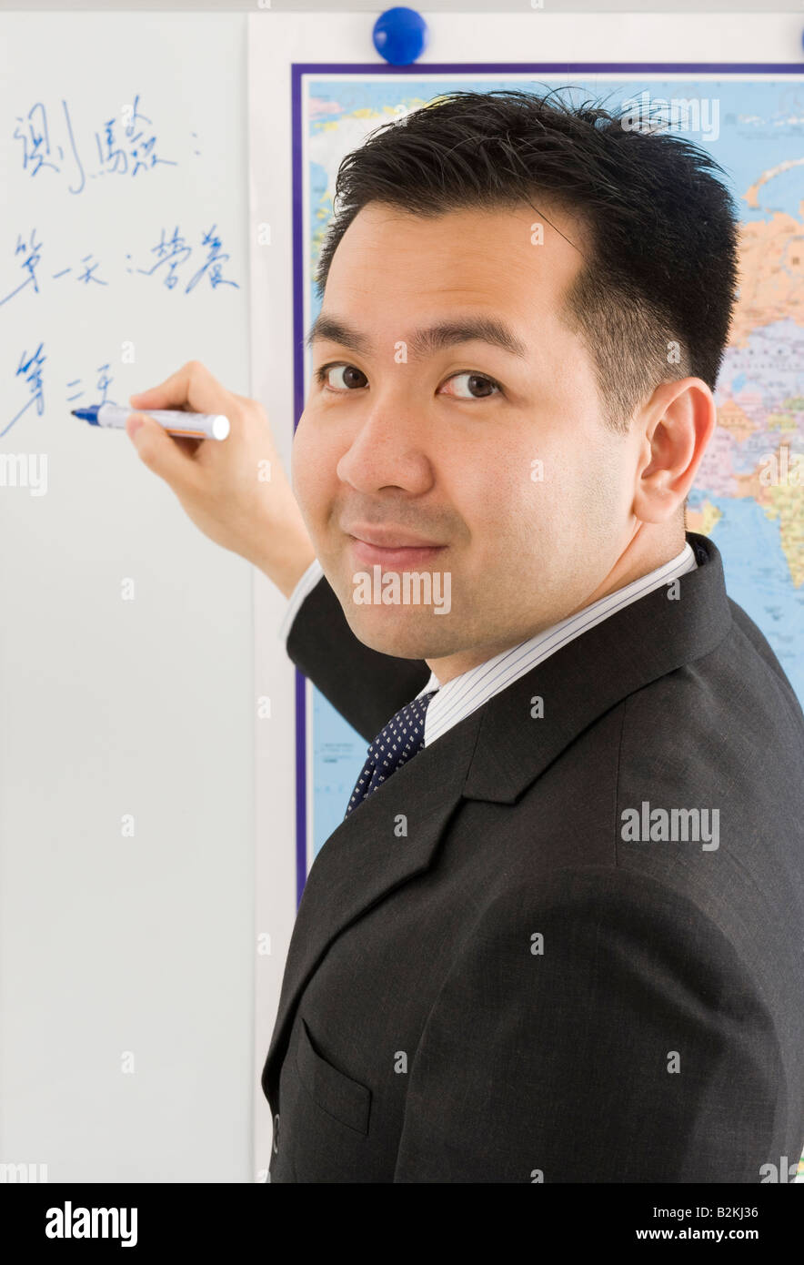Portrait of a professor writing on a whiteboard Stock Photo - Alamy