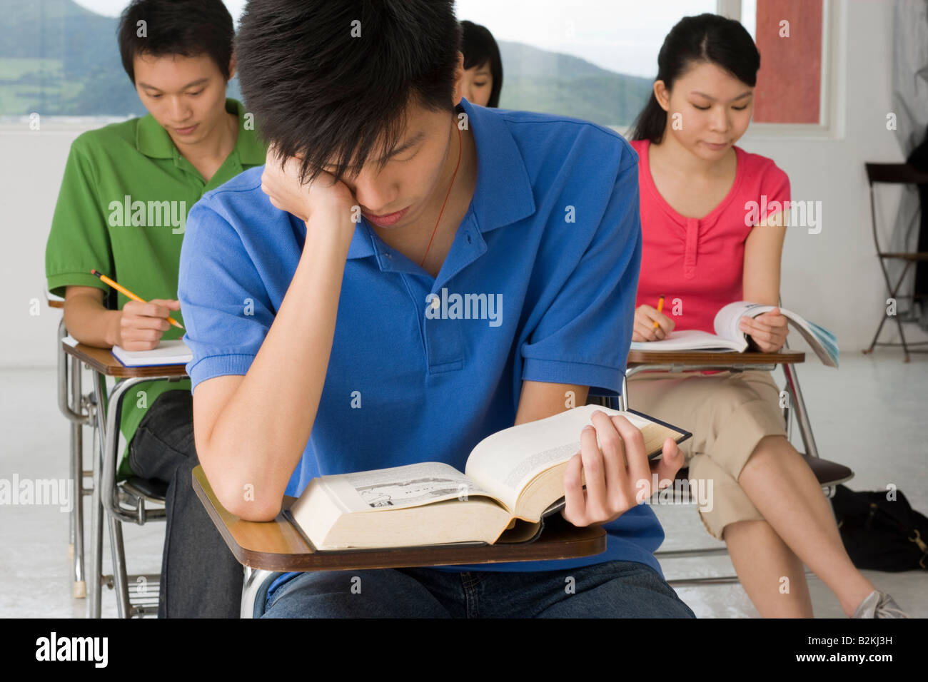 Students studying in a classroom Stock Photo - Alamy