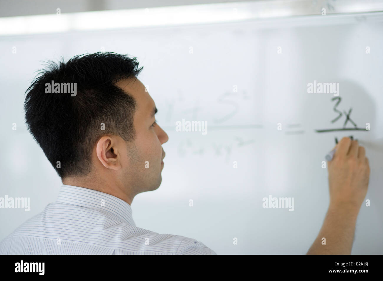 Close-up of a professor writing on a whiteboard Stock Photo - Alamy