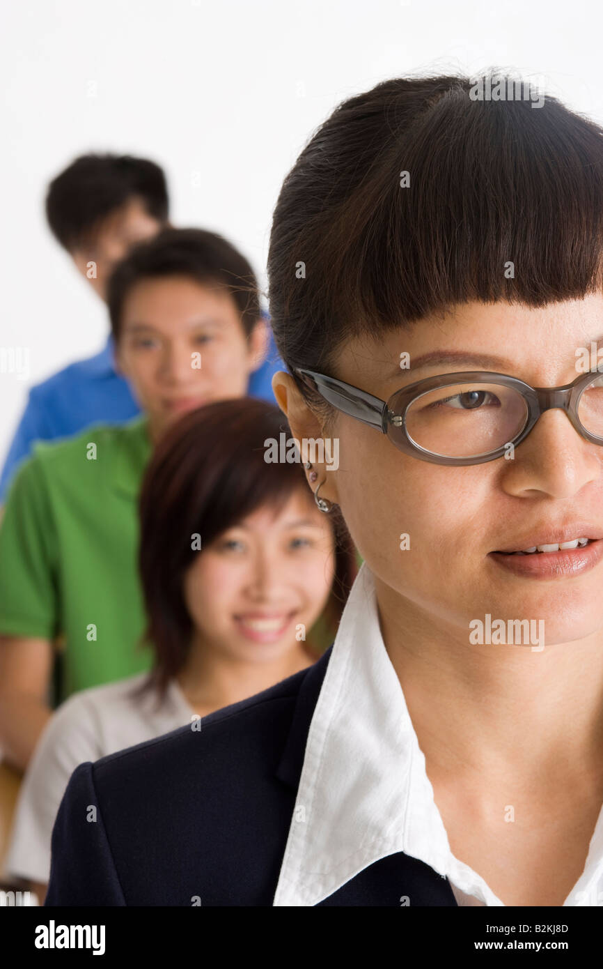 Close-up of a female professor and three university students in a row ...