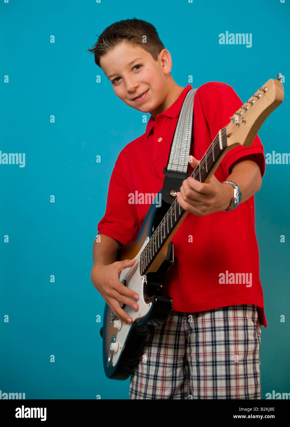Young boy playing his guitar Stock Photo - Alamy