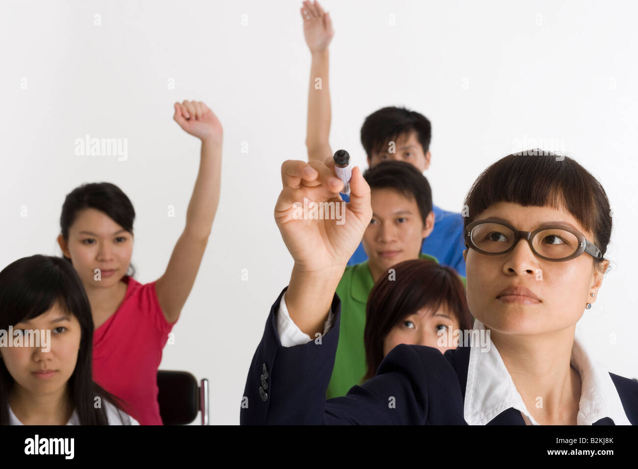 Female professor holding a felt tip pen in a classroom Stock Photo - Alamy
