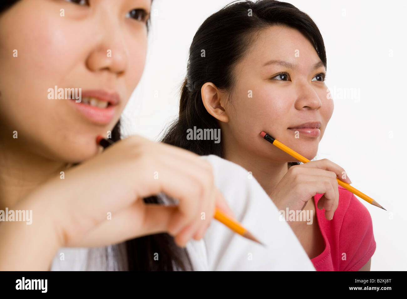Two young women studying in a classroom Stock Photo - Alamy