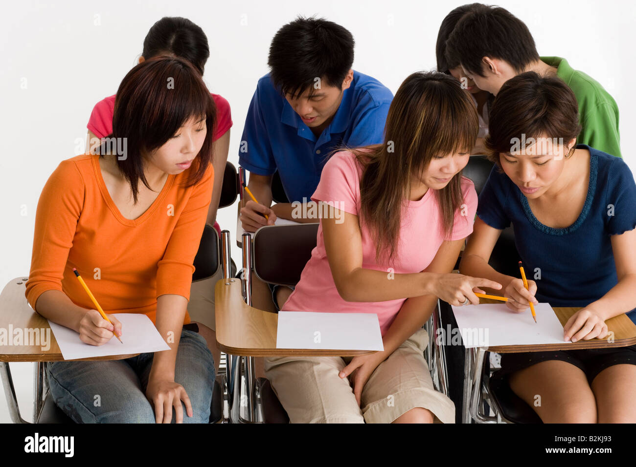 Group of college students giving exam in a classroom Stock Photo - Alamy