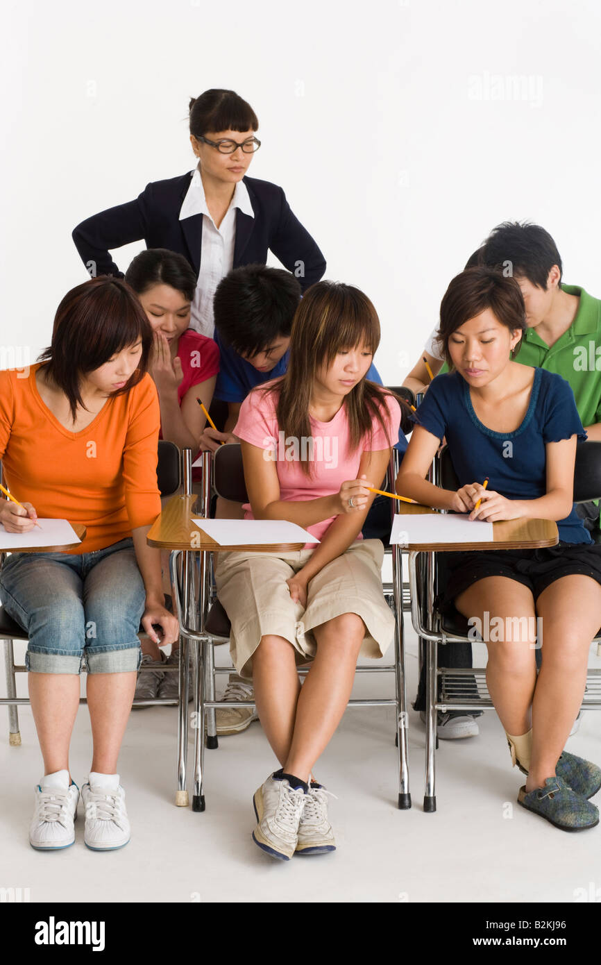Group of college students giving exam in a classroom Stock Photo - Alamy