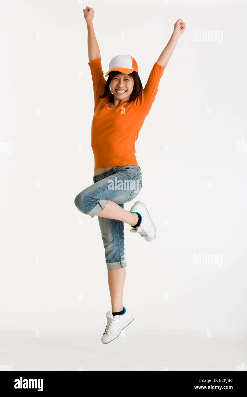 Portrait of a young woman standing on her one leg Stock Photo - Alamy