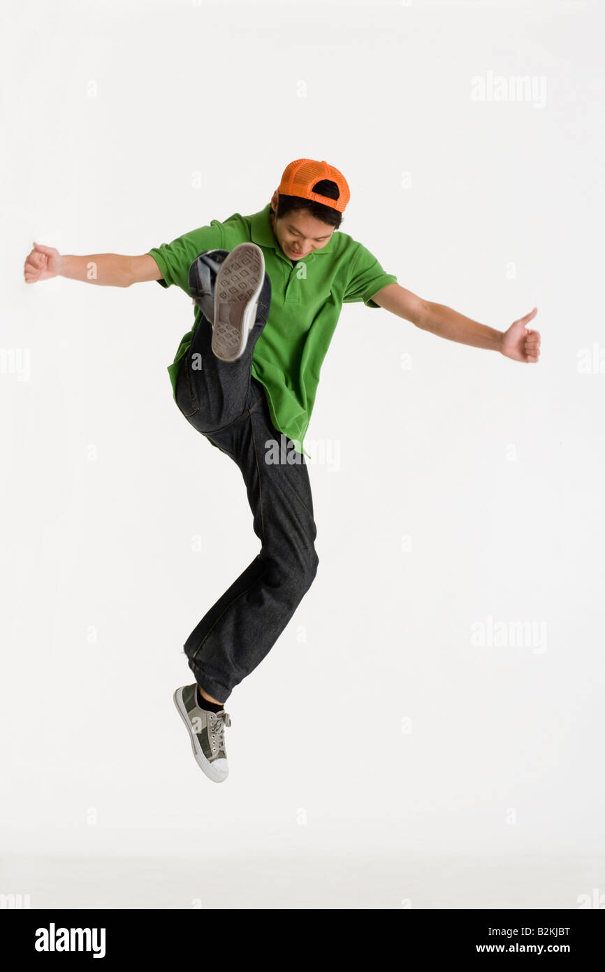 Young man kicking and jumping Stock Photo - Alamy