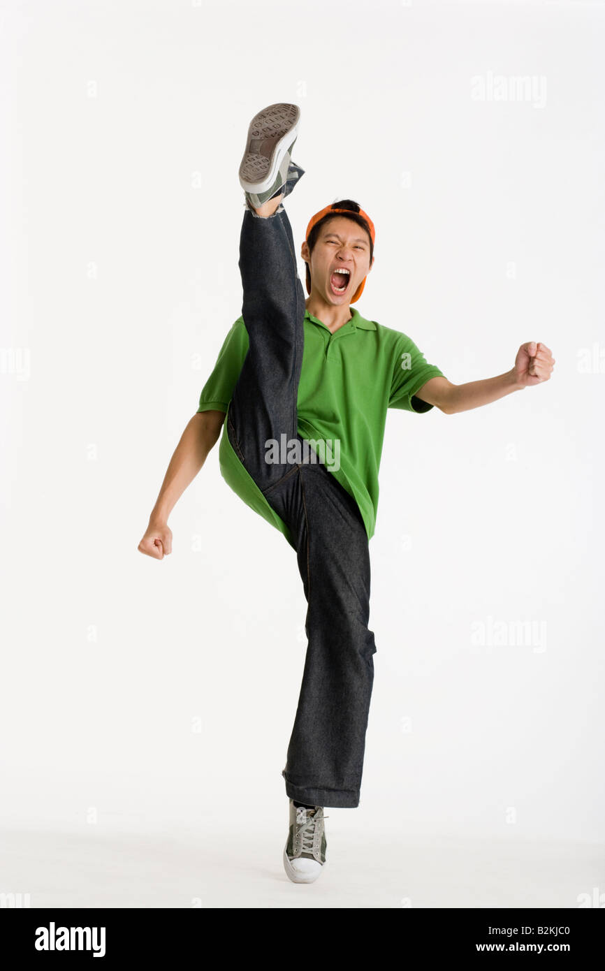 Portrait of a young man kicking and shouting Stock Photo - Alamy