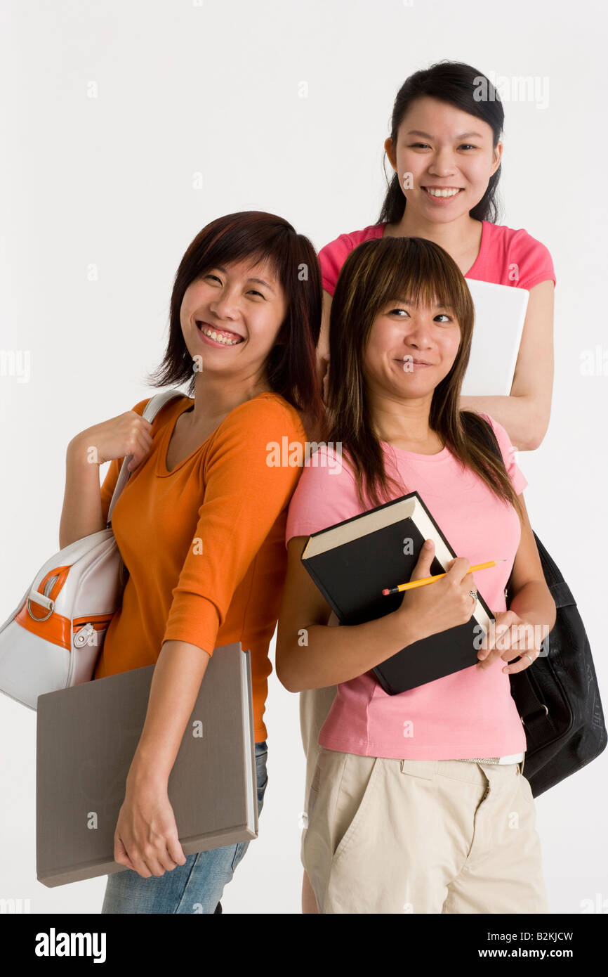 Portrait of three female university students standing and smiling ...