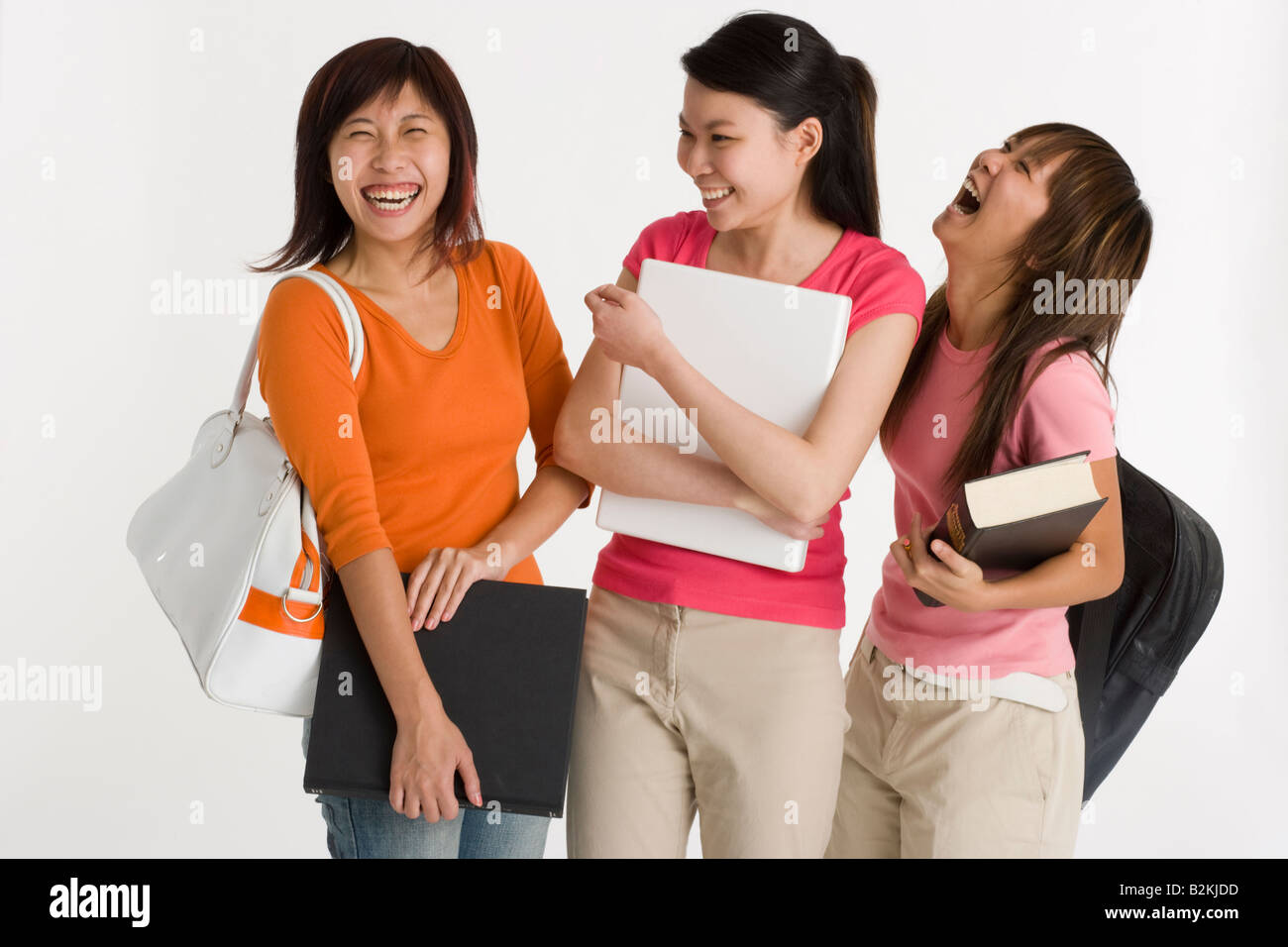 Three female university students smiling together Stock Photo - Alamy