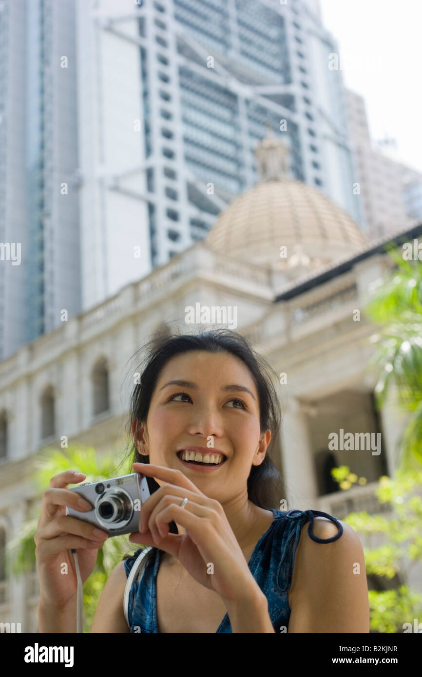 Young woman photographing with a digital camera Stock Photo - Alamy