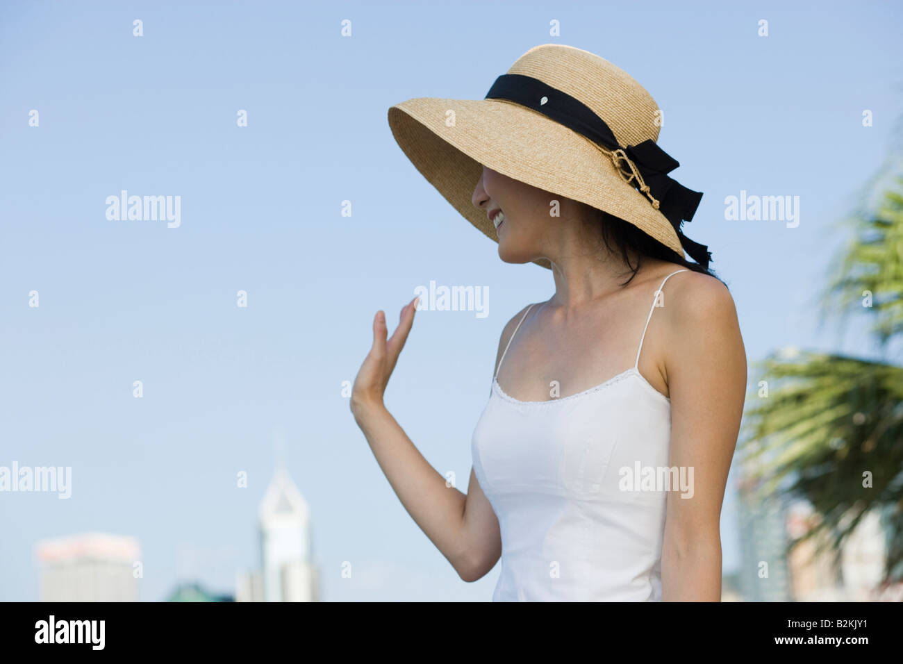 Woman waving a sun hat hi-res stock photography and images - Alamy