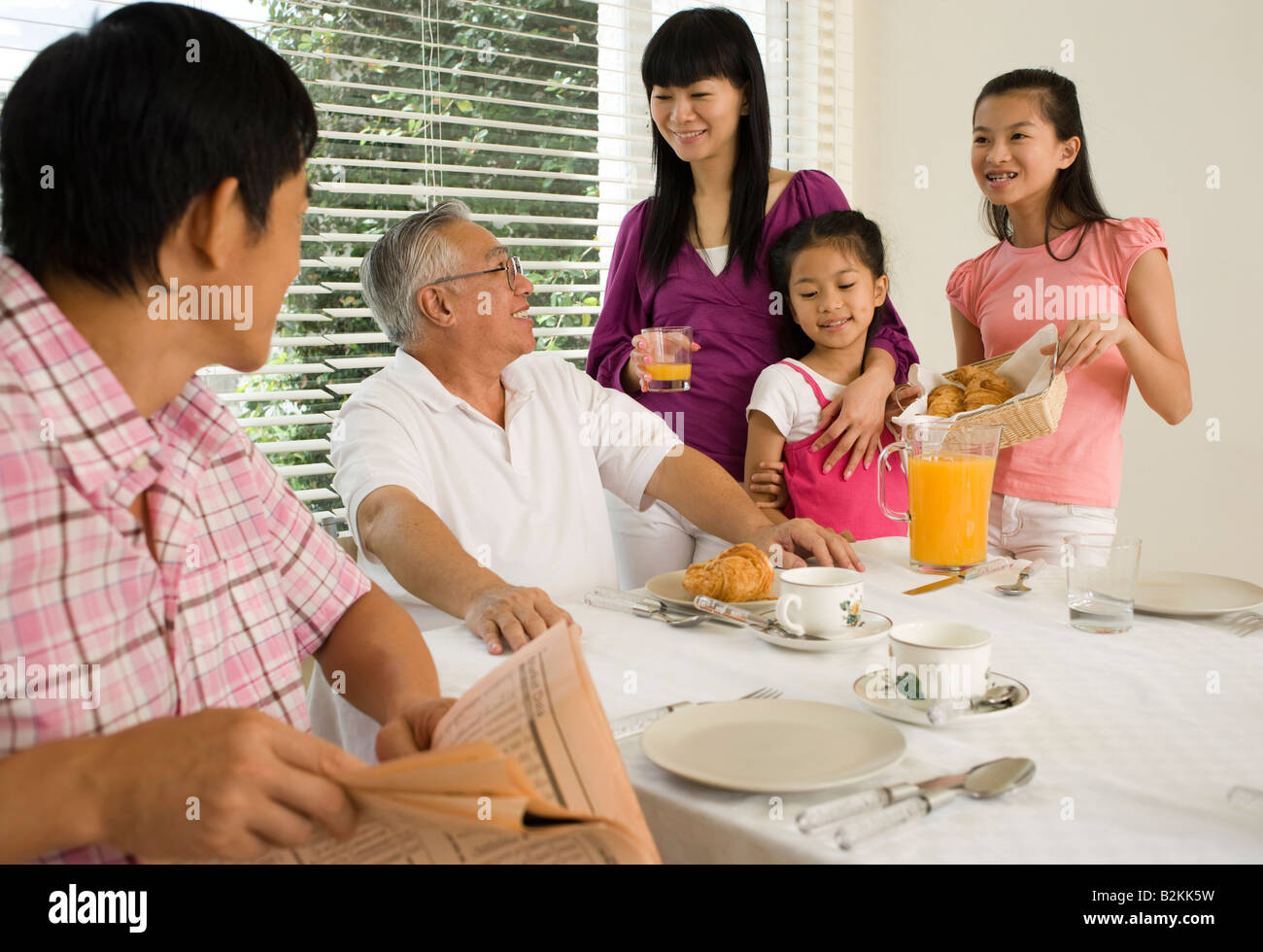 Family at a breakfast table Stock Photo - Alamy