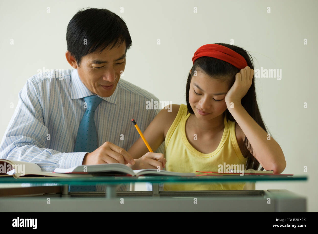 Mid adult man teaching his daughter Stock Photo - Alamy