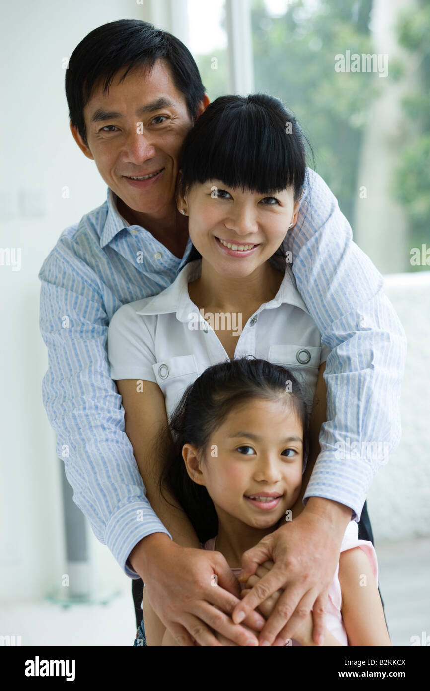 Portrait of a mid adult couple smiling with their daughter Stock Photo ...