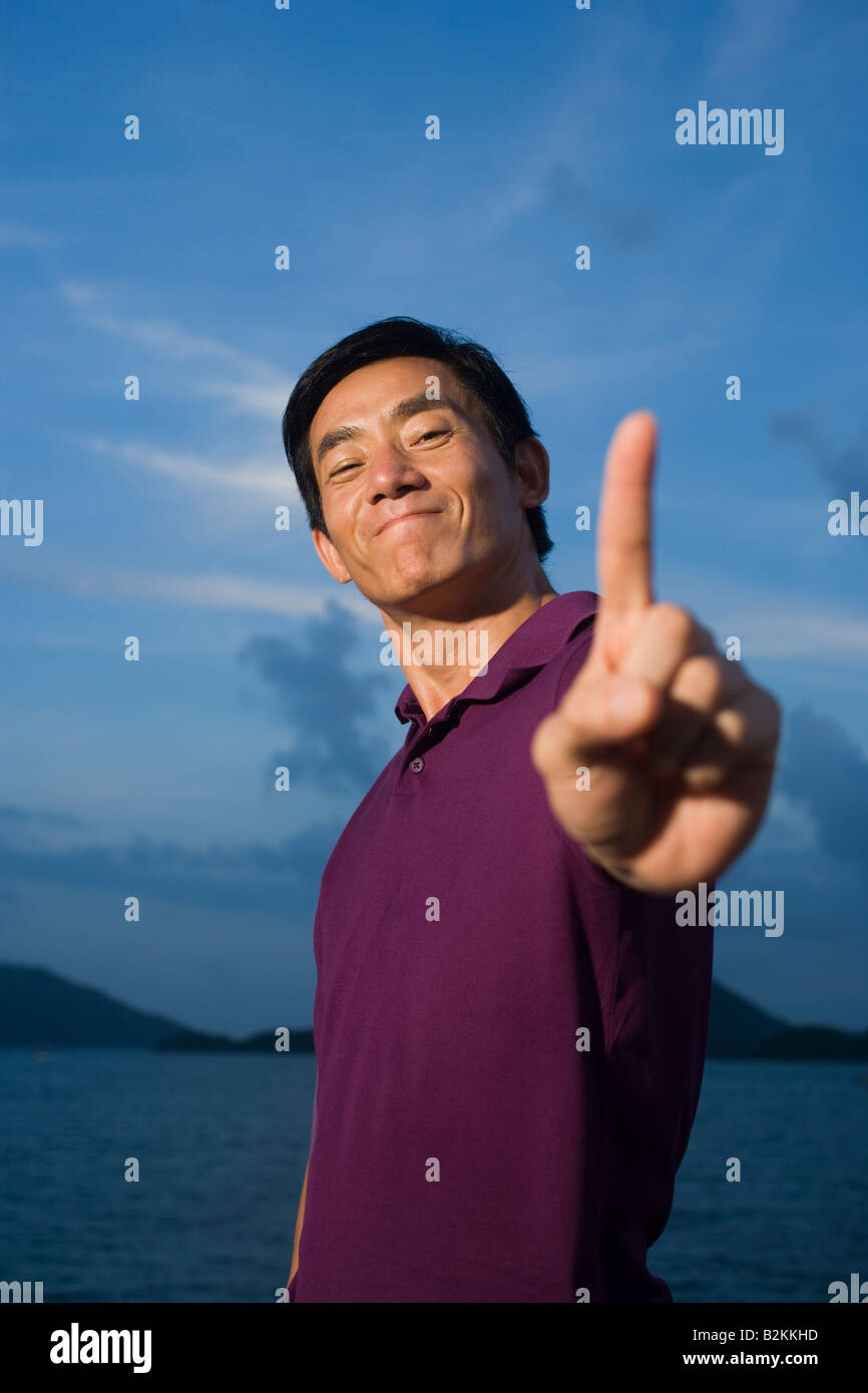 Portrait of a mid adult man pointing forward Stock Photo - Alamy