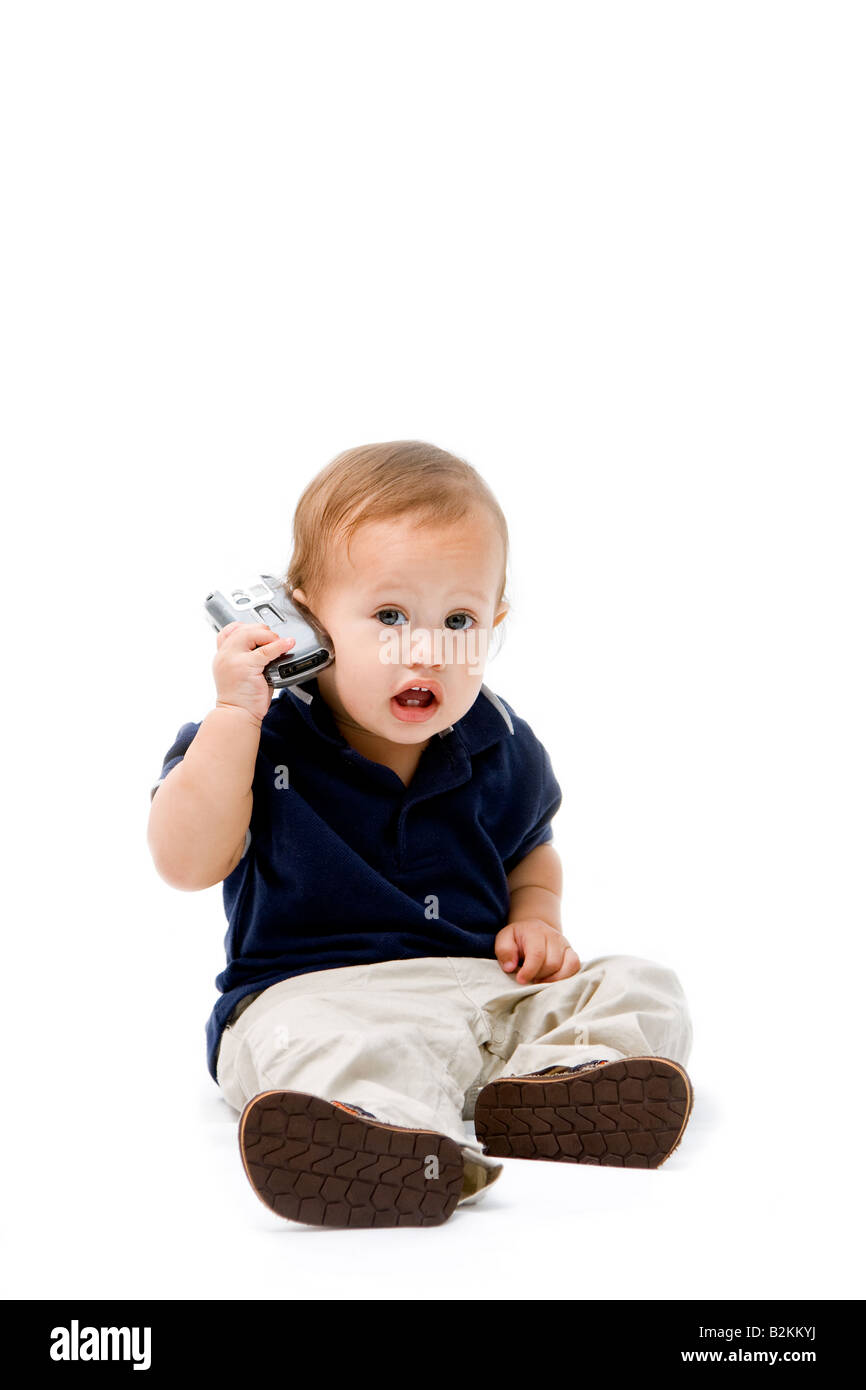 Baby sitting with phone in hand calling isolated Stock Photo - Alamy