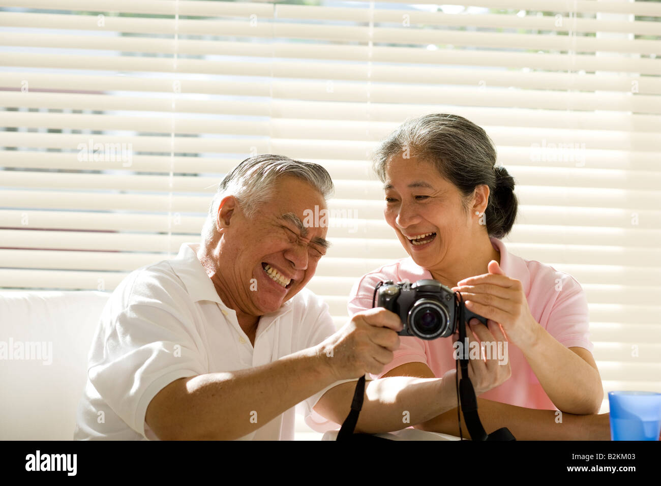 Senior man showing a video camera to a senior woman Stock Photo - Alamy