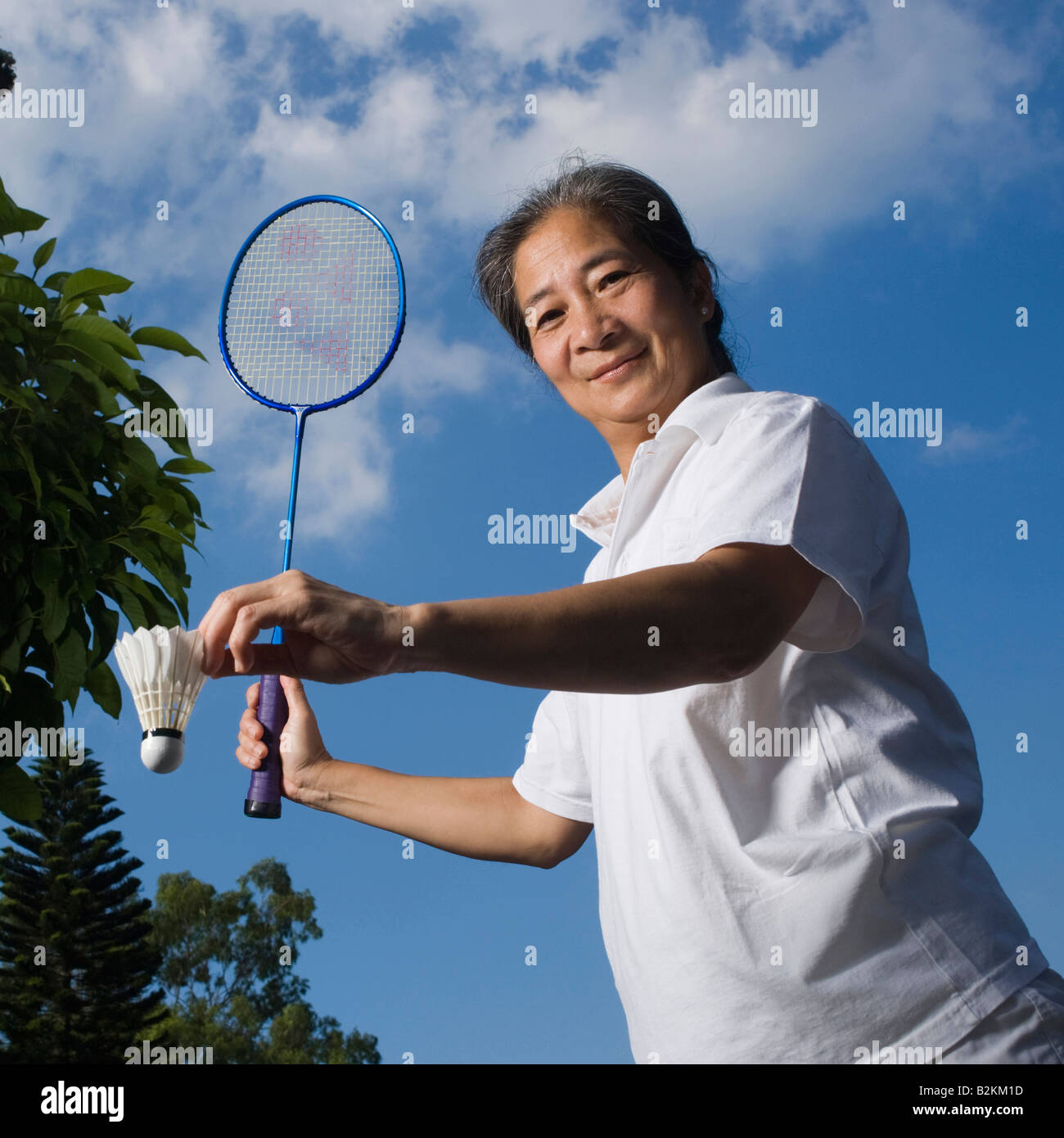 Senior woman playing badminton Stock Photo - Alamy