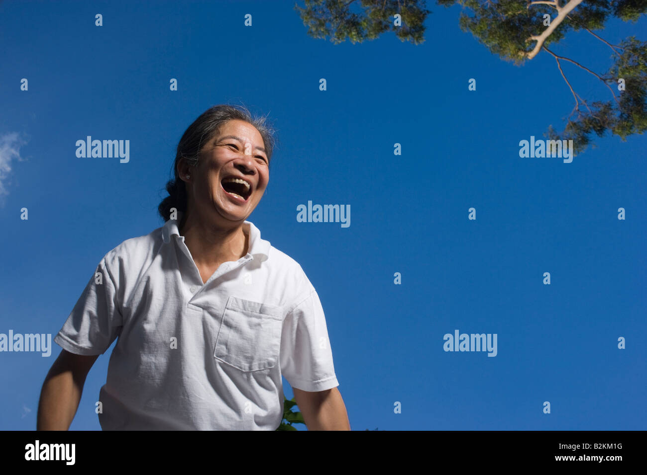 Low angle view of a senior woman laughing Stock Photo - Alamy