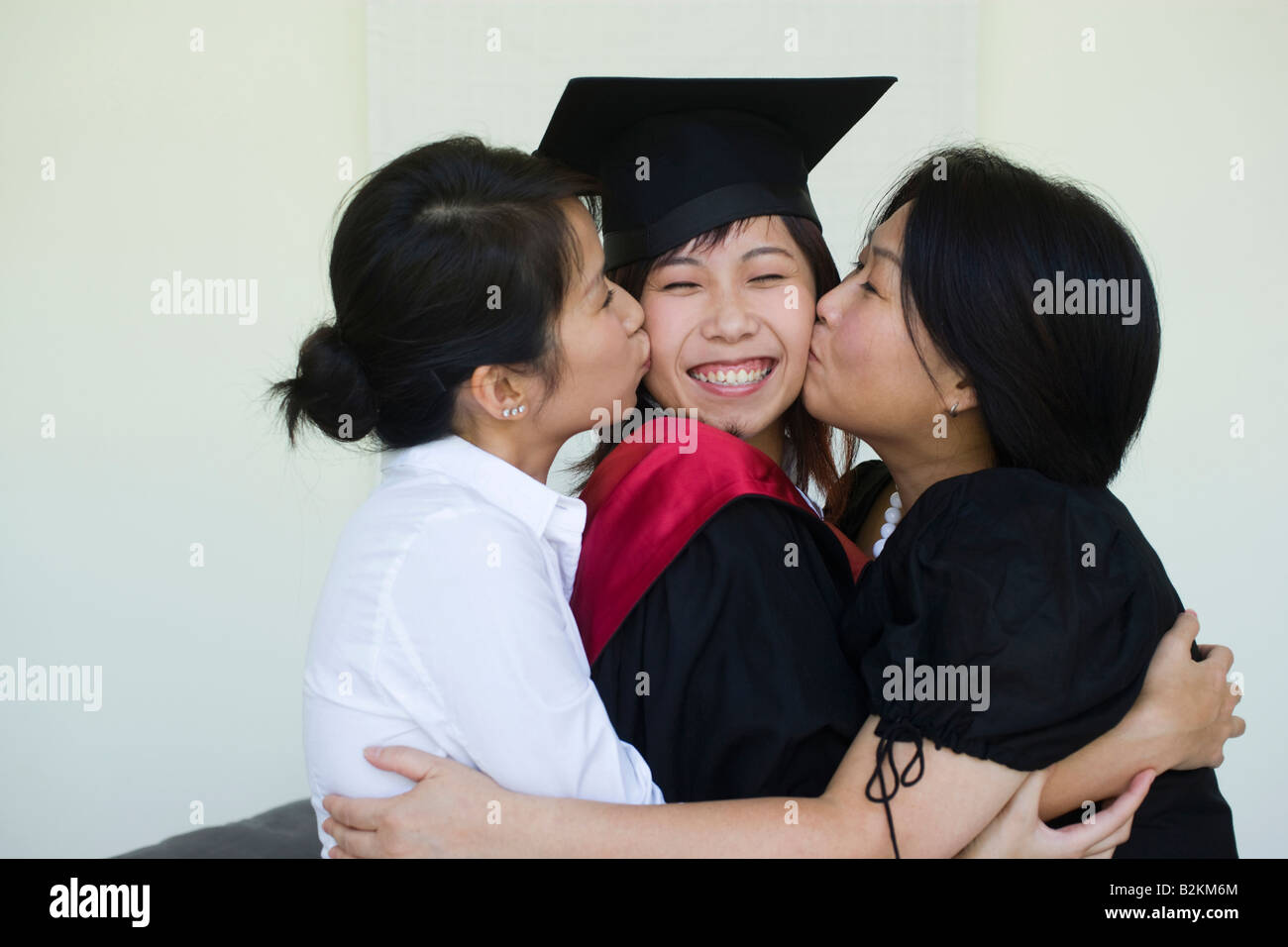 Three women kissing and hugging each other Stock Photo - Alamy