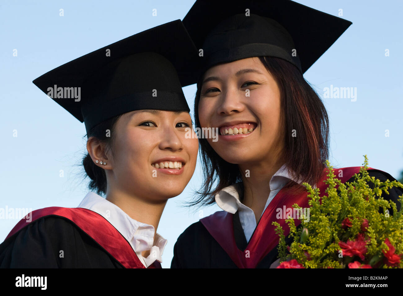 Portrait of two female graduates smiling Stock Photo - Alamy