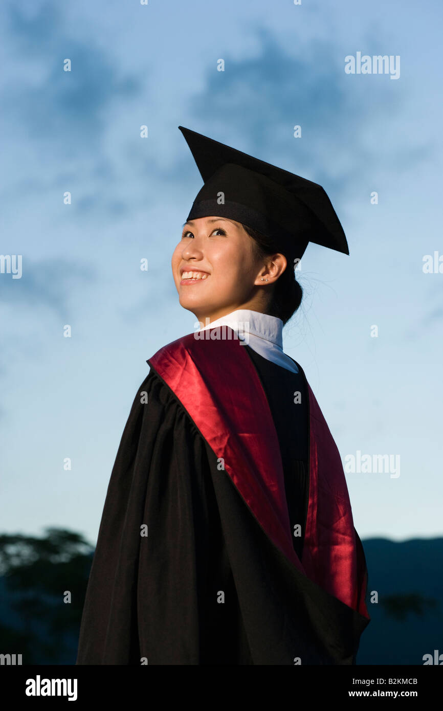 Side profile of a young female graduate smiling Stock Photo - Alamy
