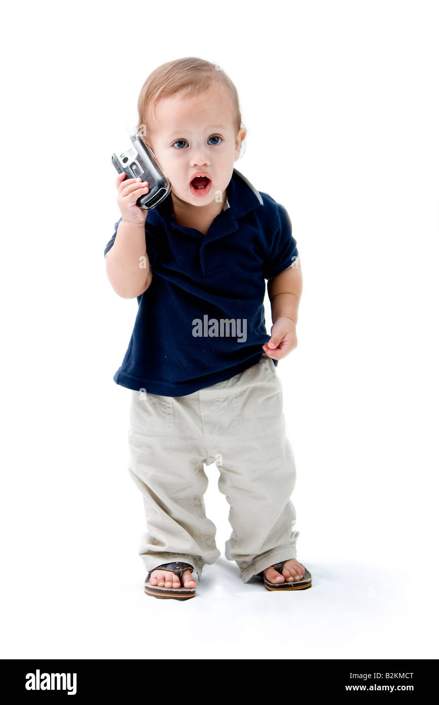 Baby standing with phone in hand calling and mouth open isolated Stock ...