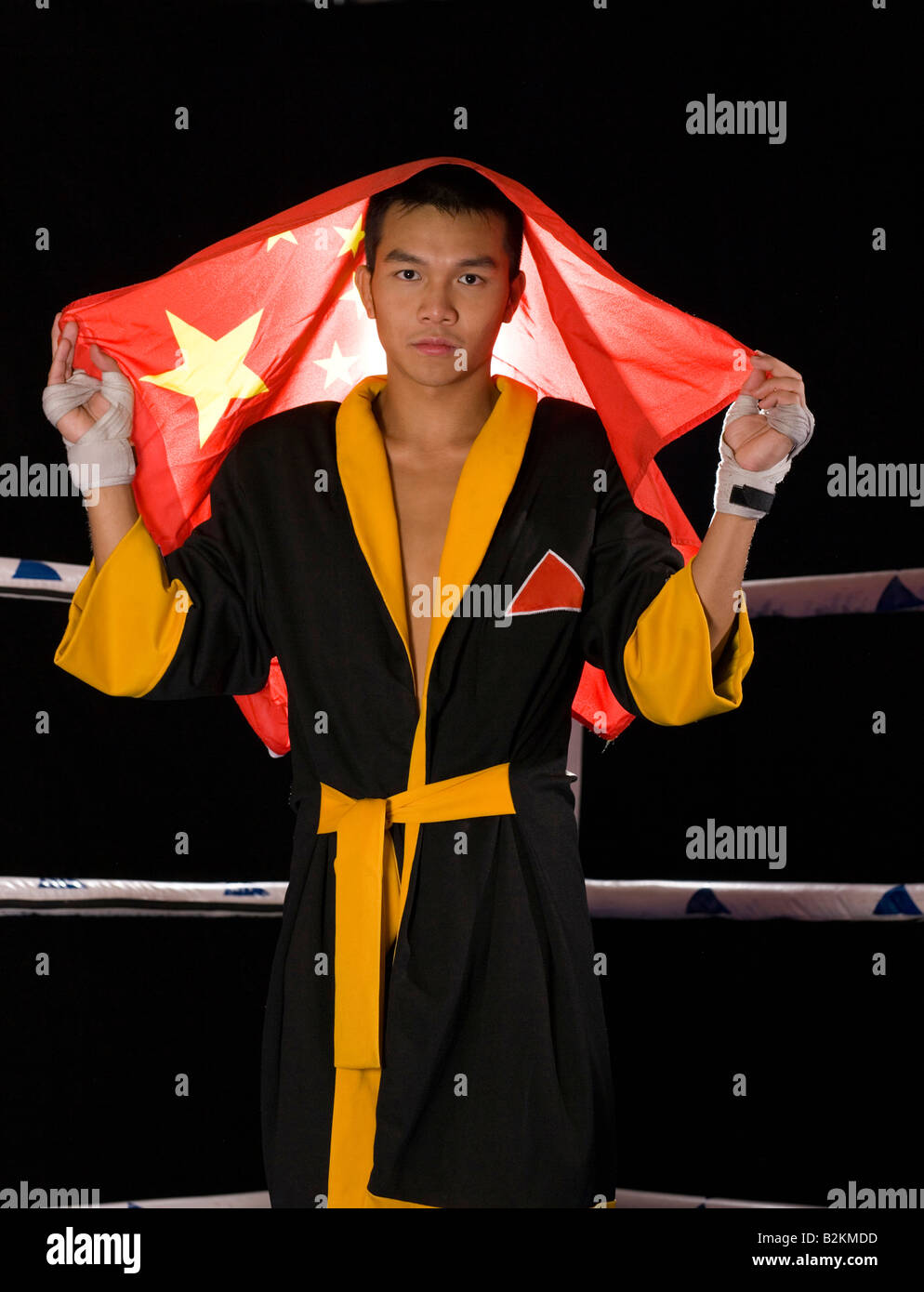 Young man holding a Chinese flag in a boxing ring Stock Photo - Alamy