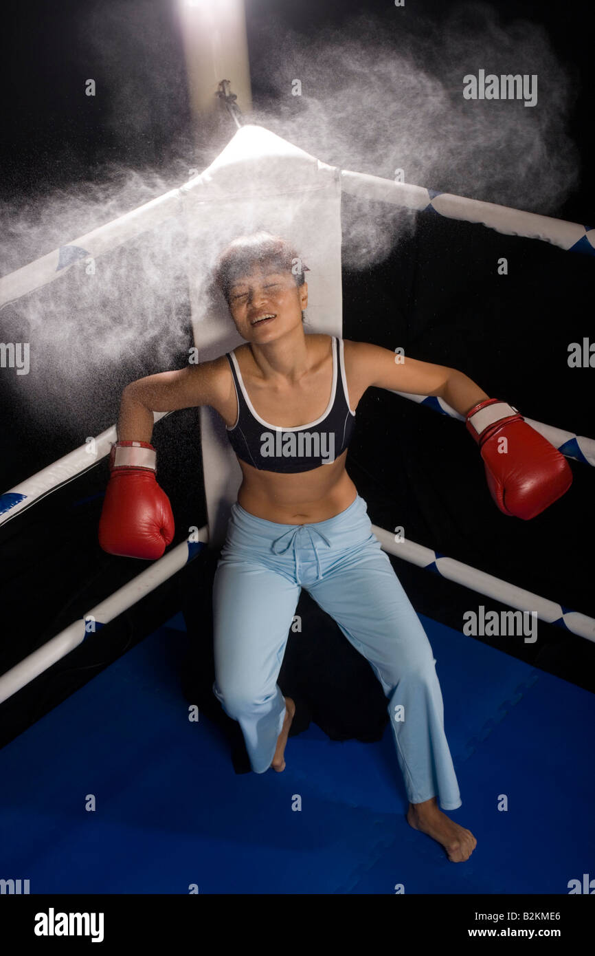 Young woman resting at a corner of a boxing ring Stock Photo - Alamy