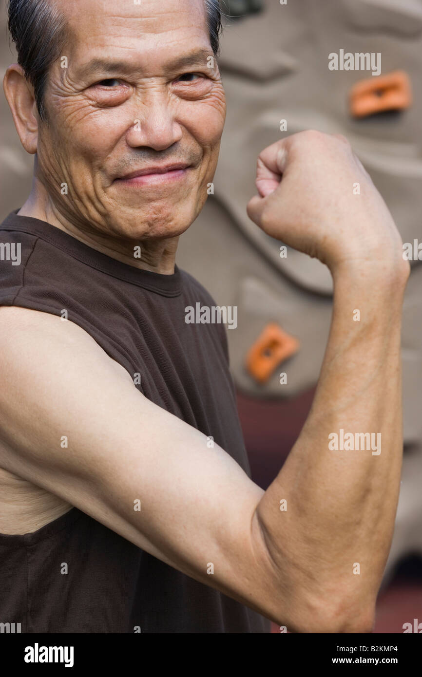 Portrait of a senior man flexing his muscles and smiling Stock Photo ...