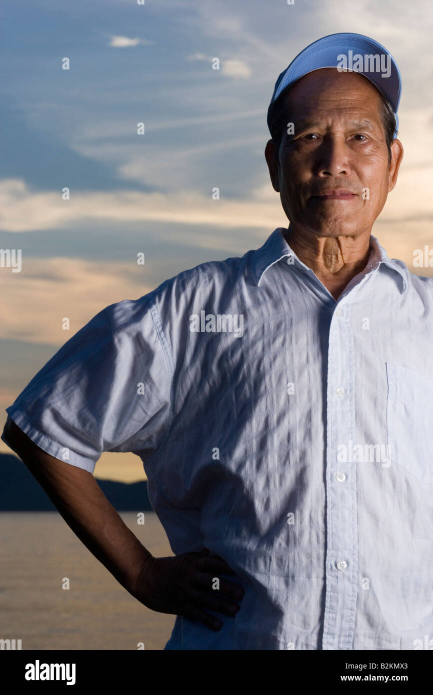 Portrait of a senior man standing with his hand on his hip Stock Photo ...