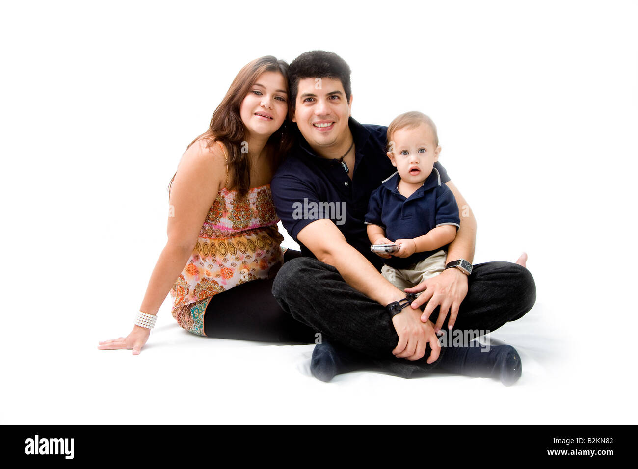 Mother father and son as a young new family sitting together isolated ...