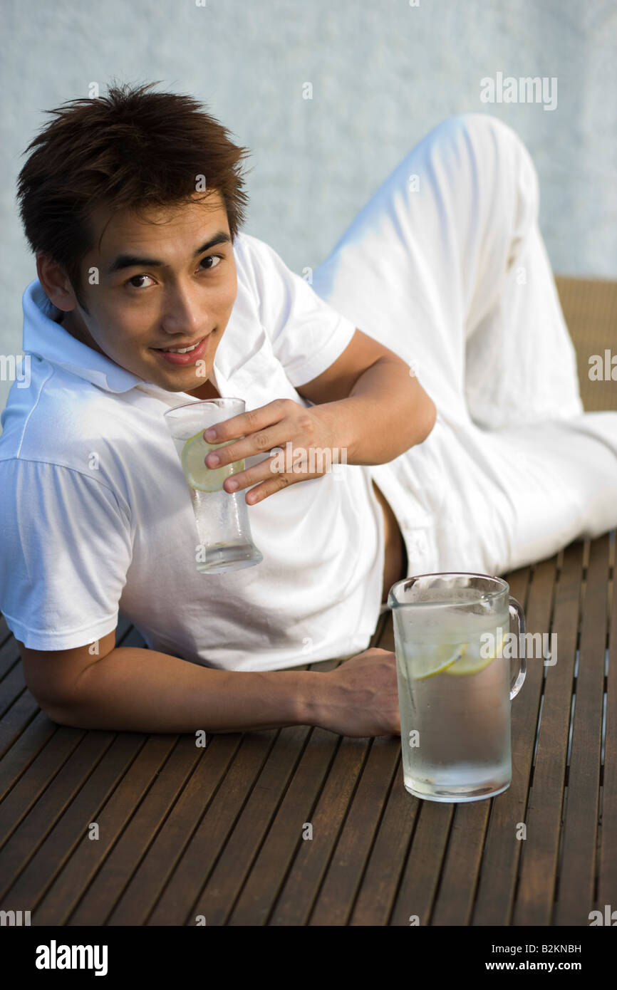 Portrait of a young man drinking lemonade Stock Photo - Alamy