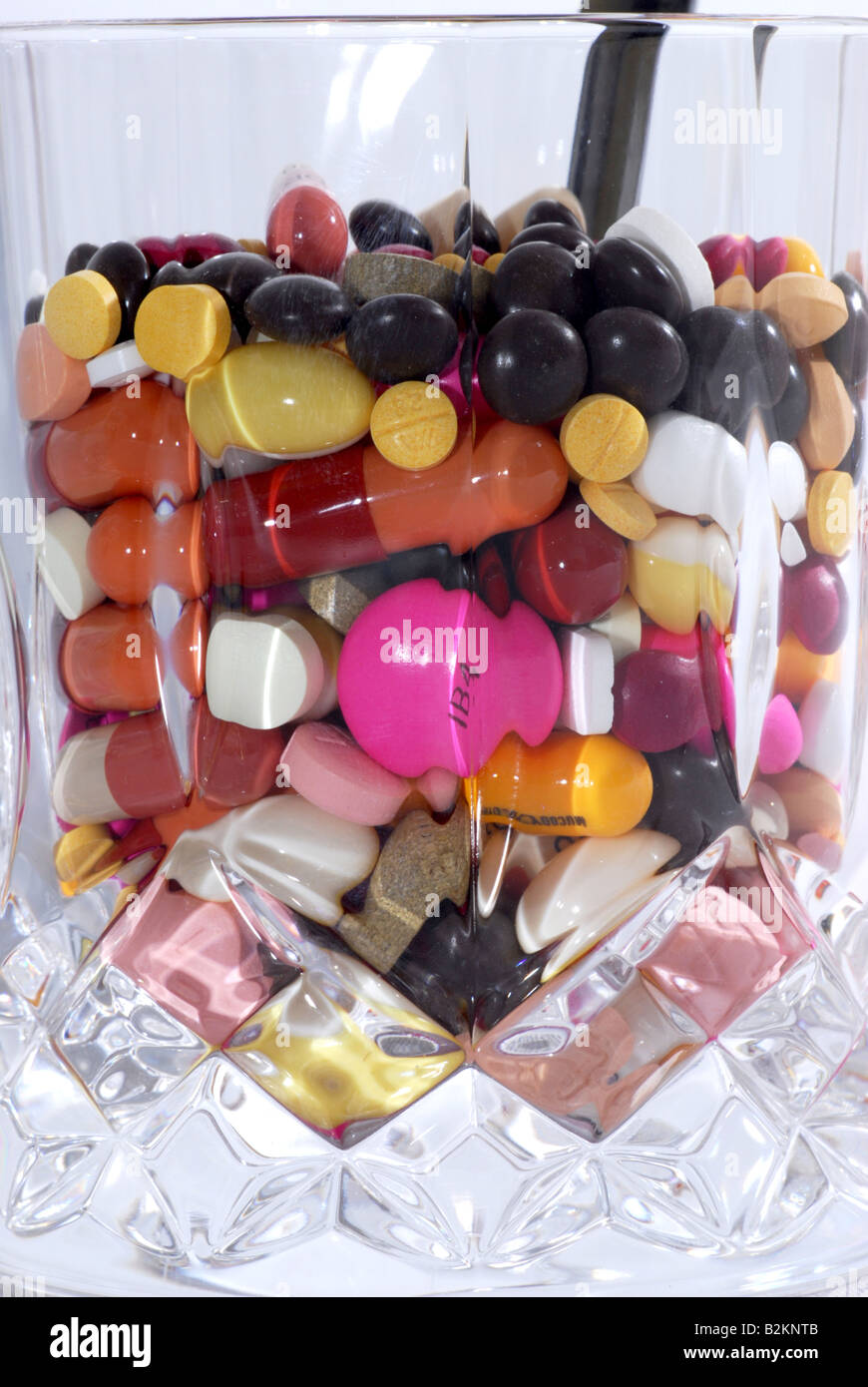 glass of tablets to illustrate the colours shapes and sizes of ...
