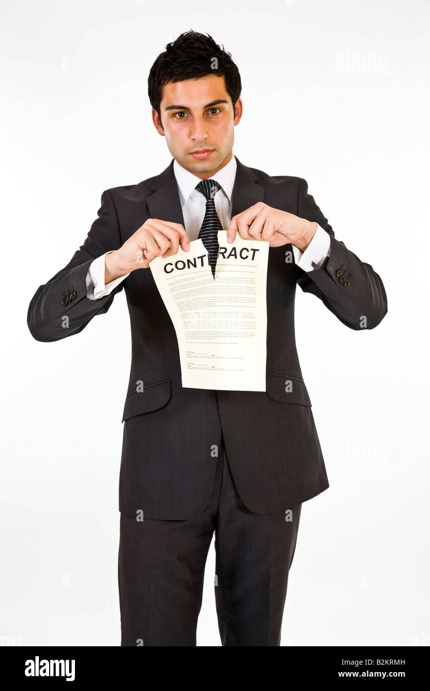 A man in a suit tearing up a contract Stock Photo - Alamy