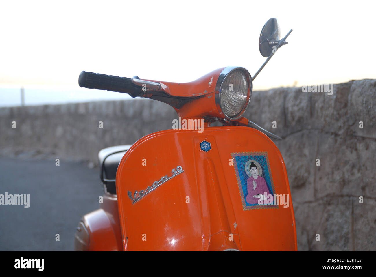 Close-up detail of an old retro scooter ( Vespa ) with a religious good ...