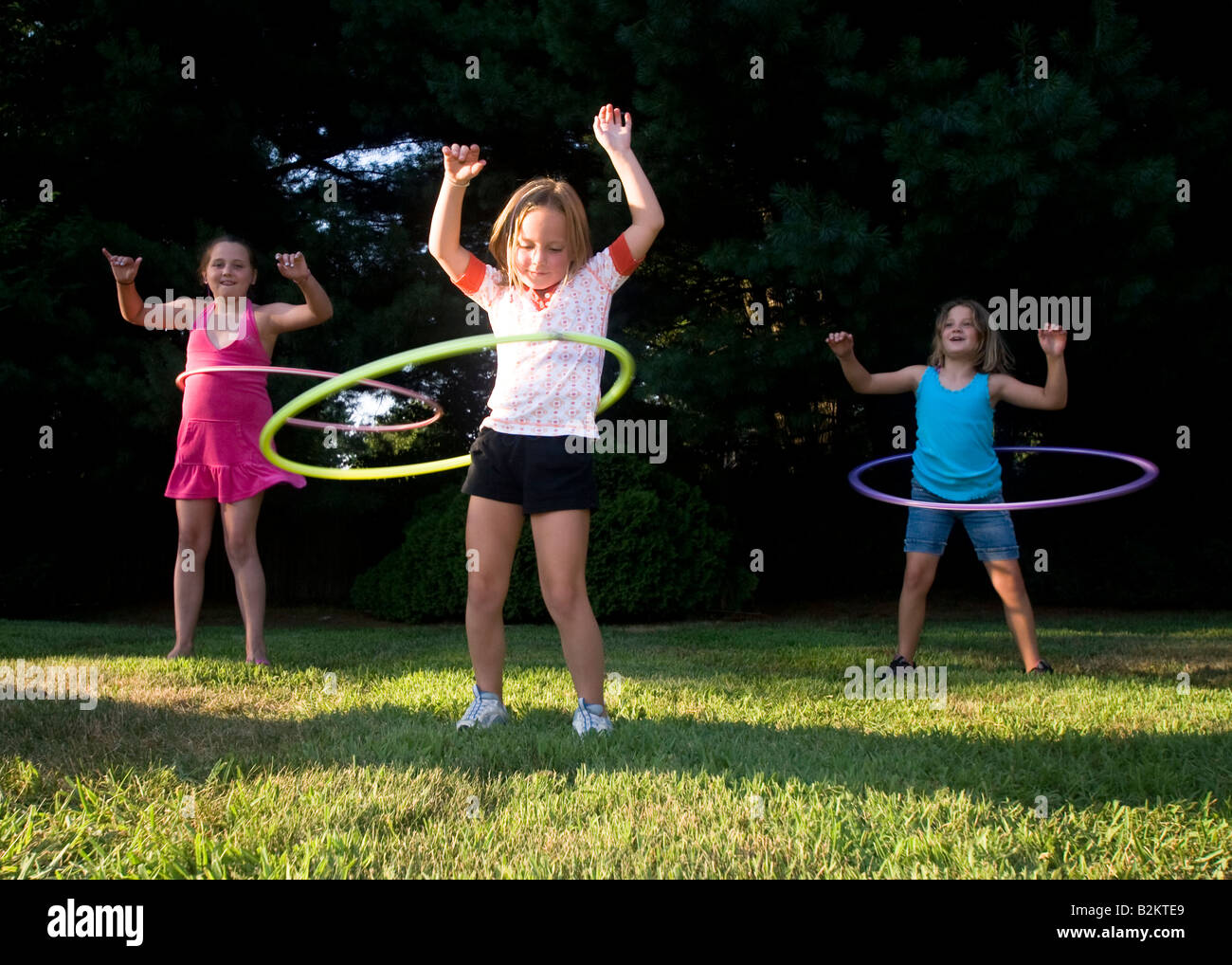 Three girls with hula hoops Stock Photo - Alamy