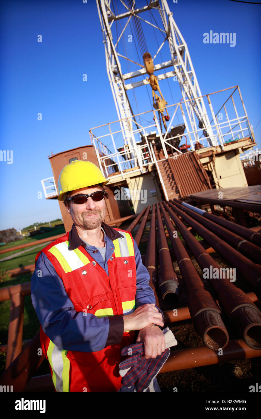 Oil drilling rig with workman in Alberta Canada Stock Photo - Alamy