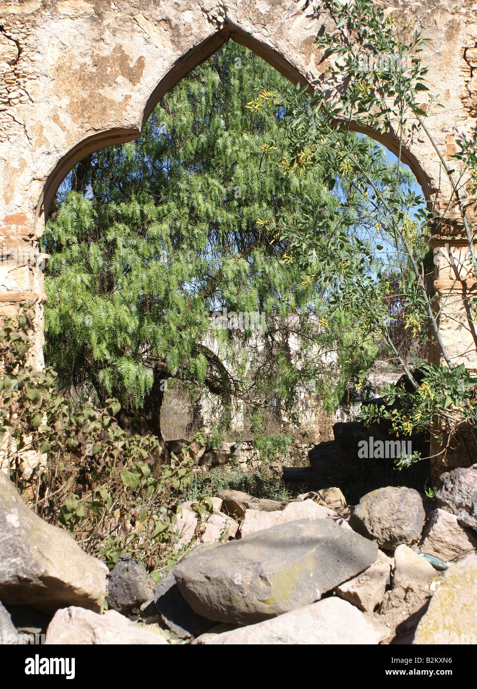Old Mexico rock wall with unusual arch Stock Photo - Alamy