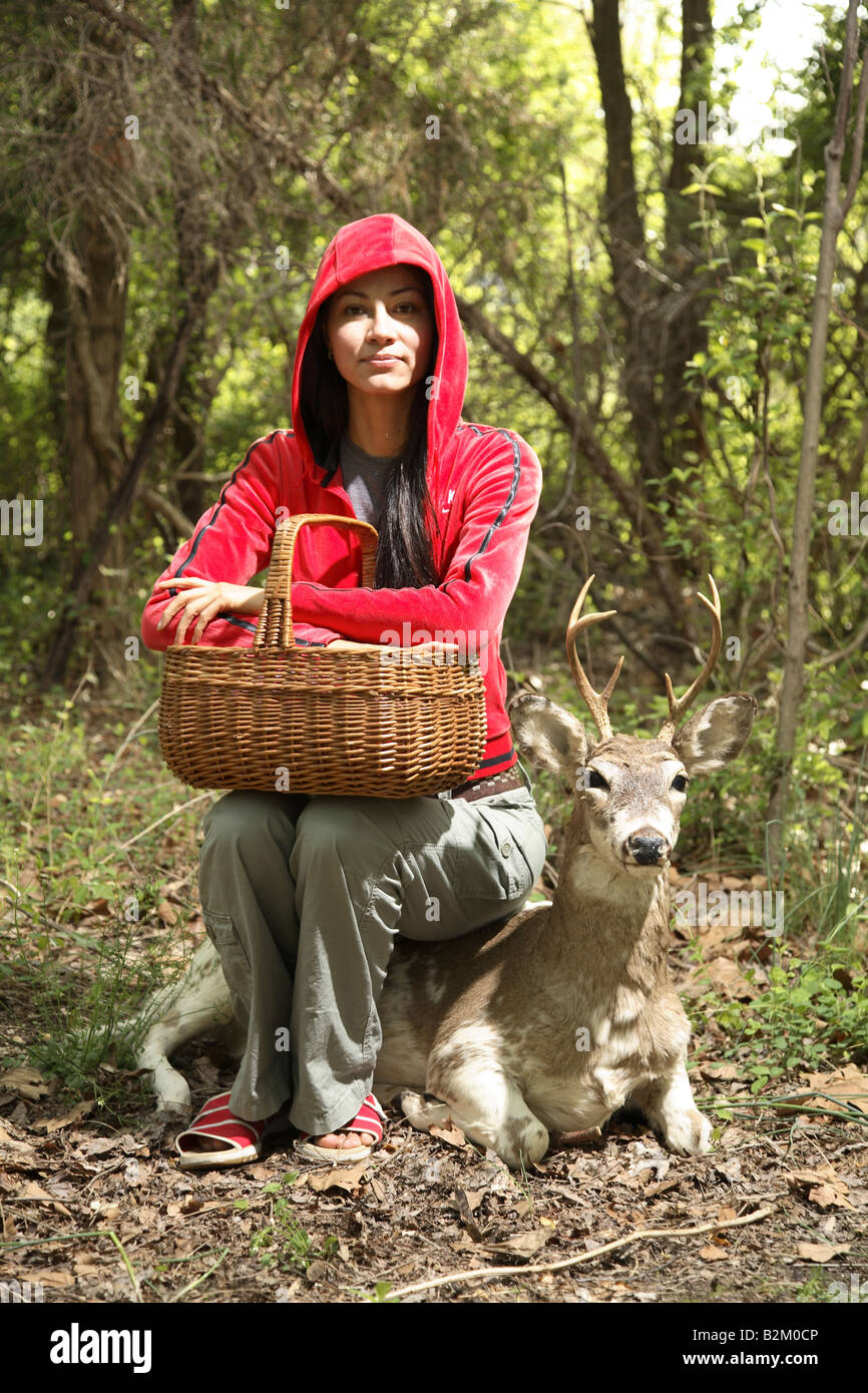 Asian woman sitting on fake deer Stock Photo - Alamy