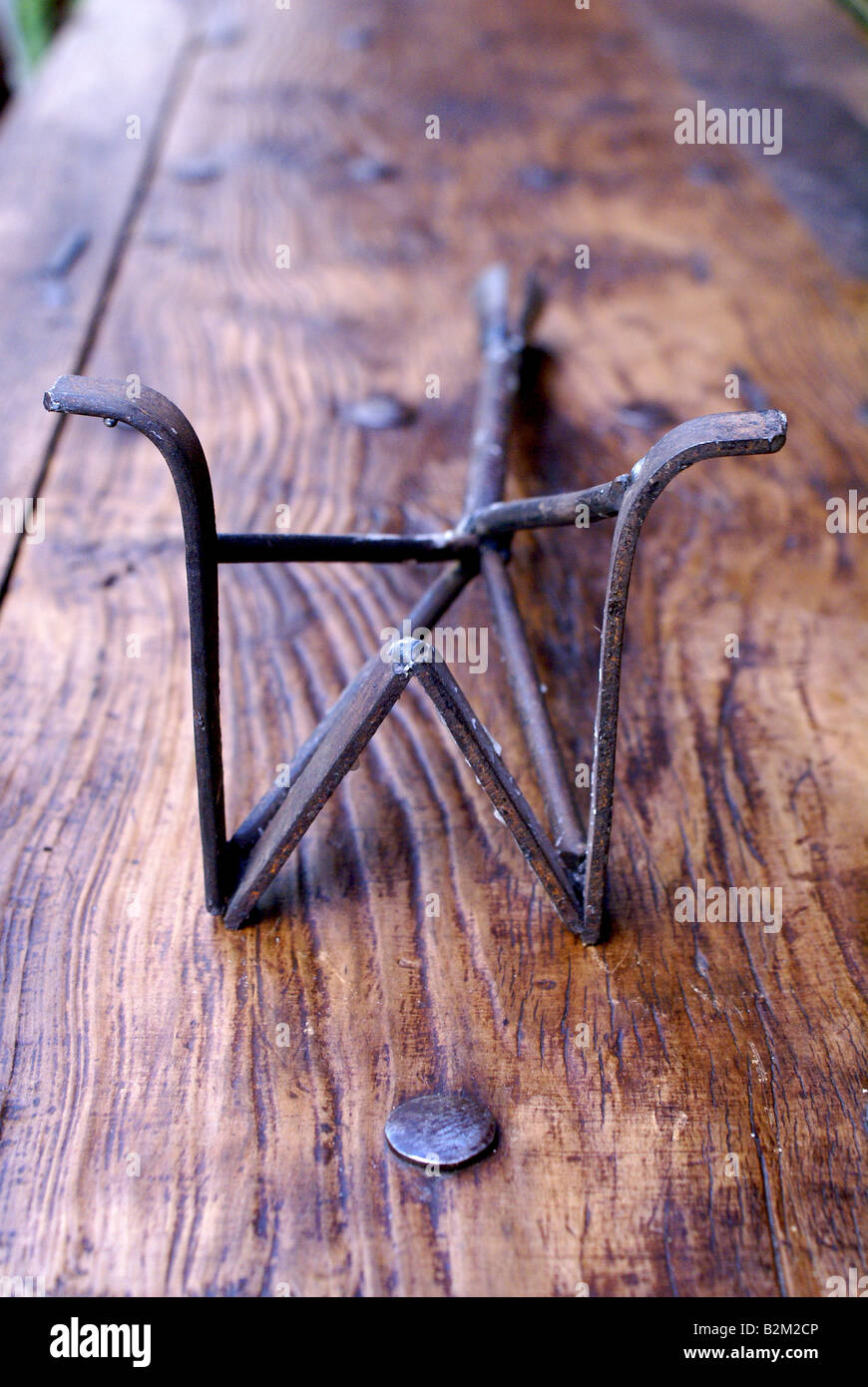 Branding iron on wooden table Stock Photo - Alamy