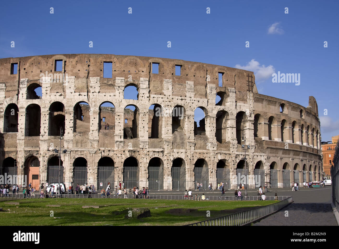Colloseum with green grass over blue sky Stock Photo - Alamy