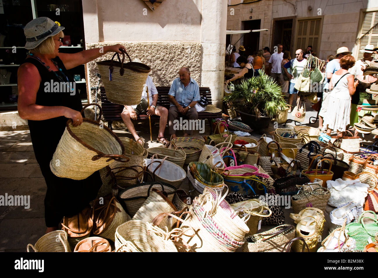 Woman chooses a raid basket to buy at the farmer's market in Sineu ...