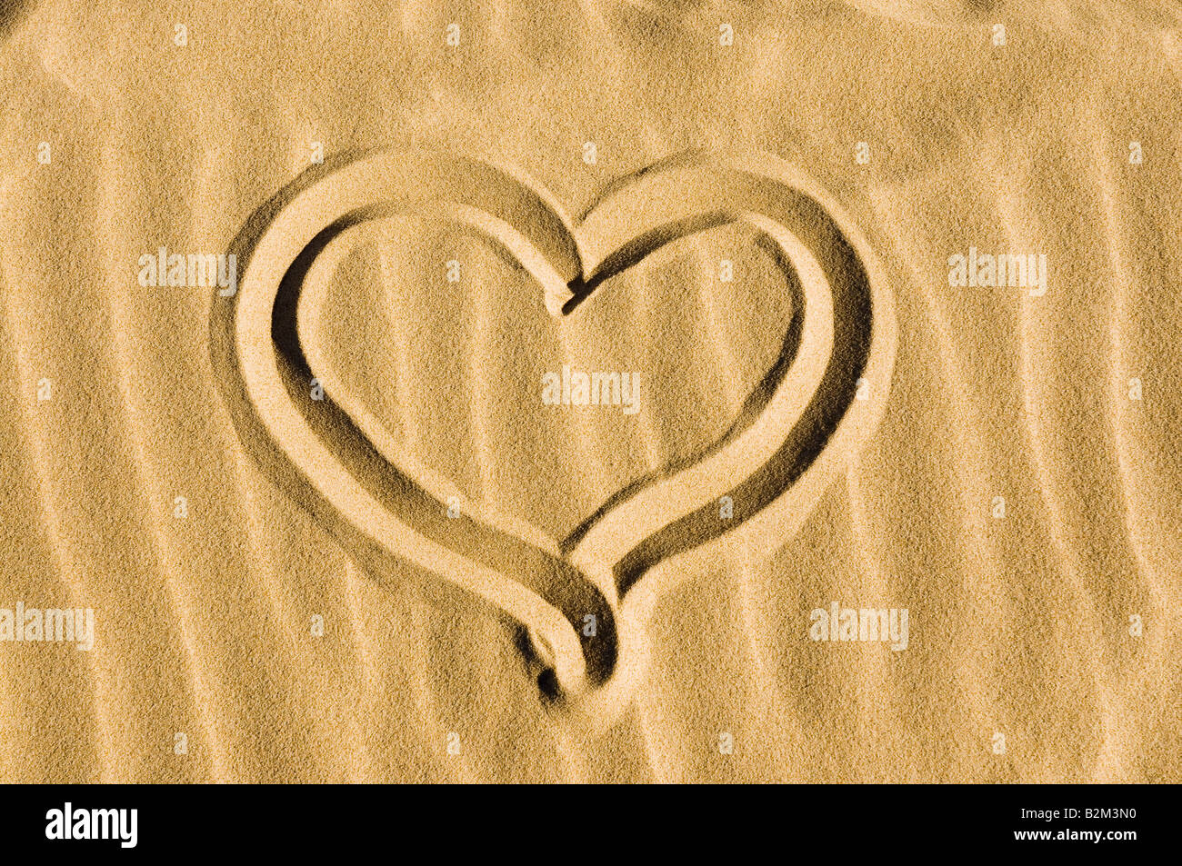 Heart drawn into sand Stock Photo - Alamy