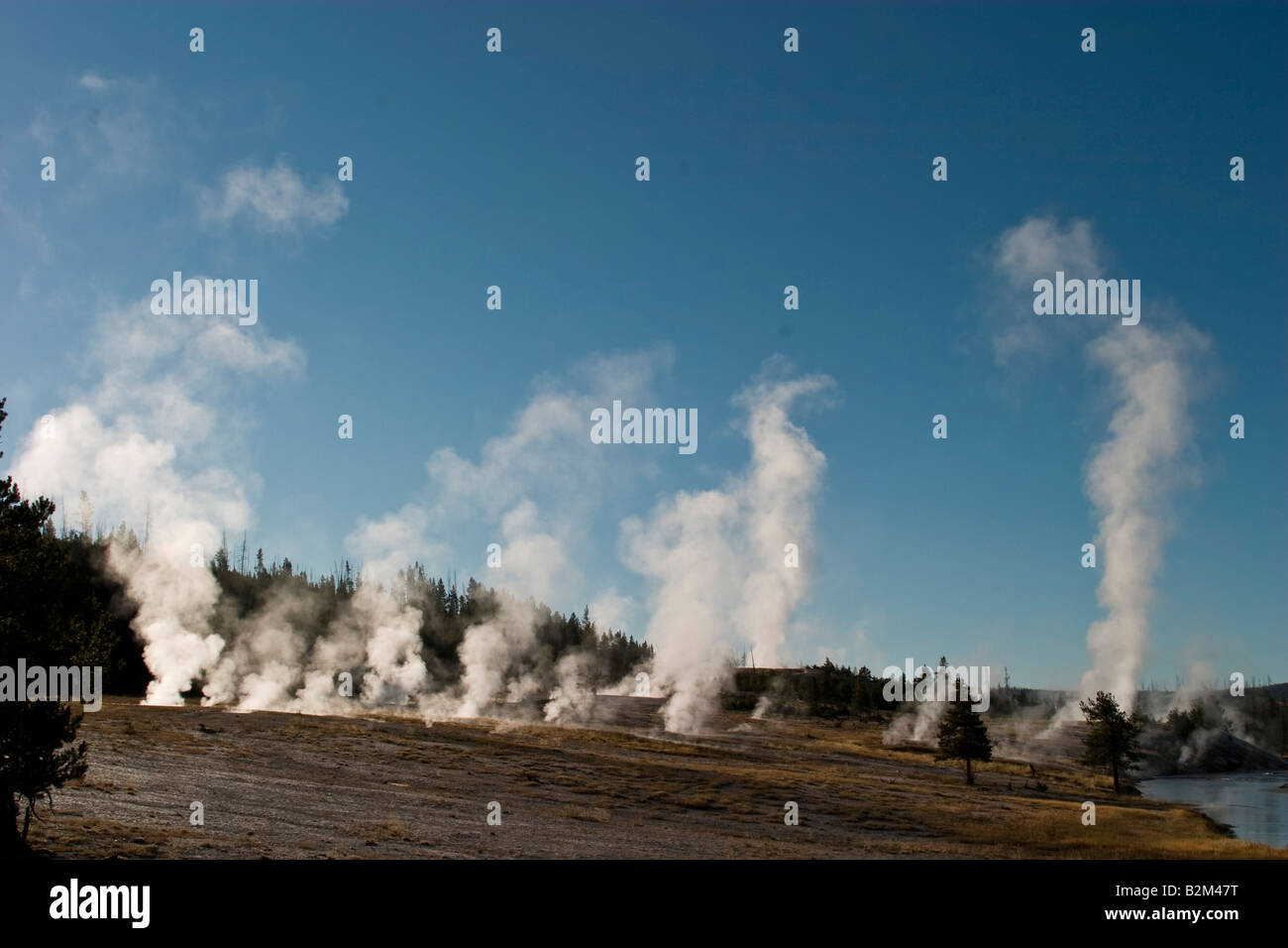 geyser steam against blue sky Stock Photo - Alamy