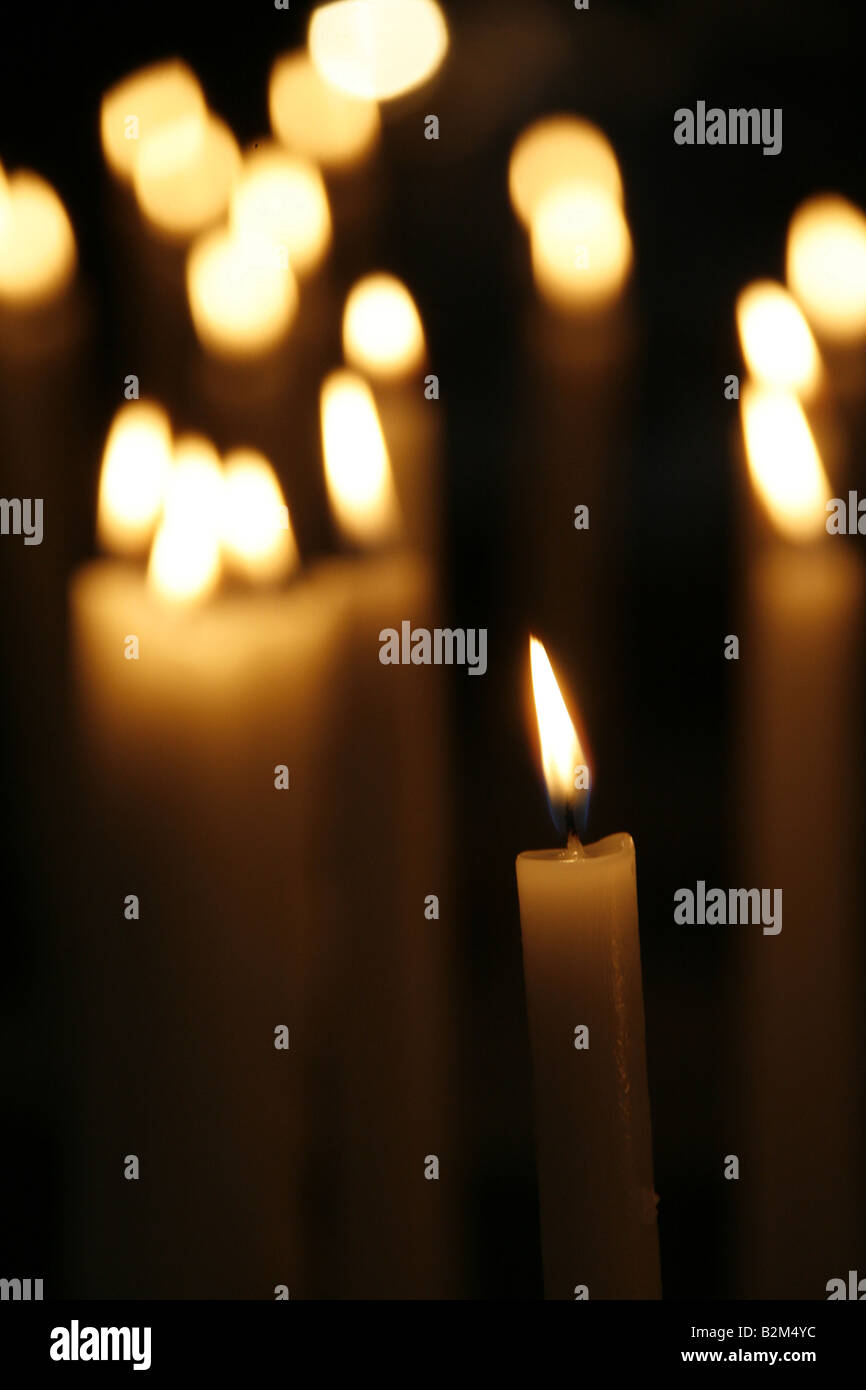 many lit candles in dark room in church Stock Photo - Alamy