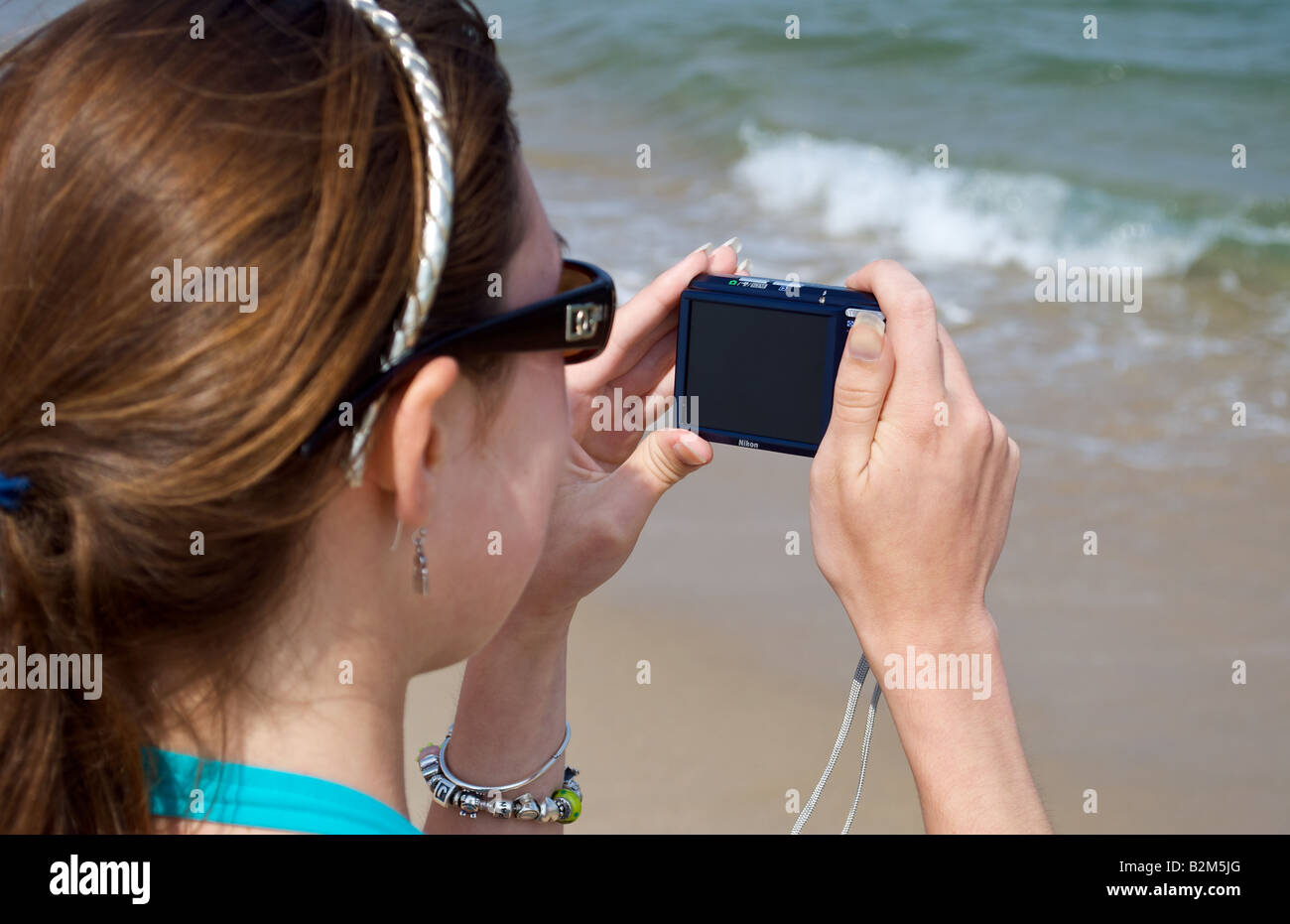 woman taking a pictures with compact digital camera Stock Photo - Alamy
